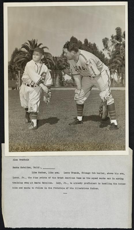 Like father, like son. Larry French, Chicago Cub hurler, shows his son ...