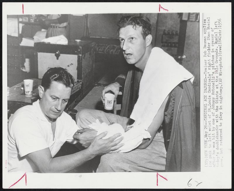 Cardinal Ace Injured--Trainer Bob Bauman applies ice pack to left wrist ...