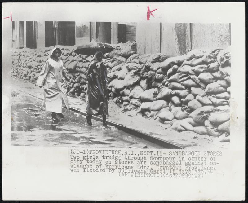 Sandbagged Stores Two girls trudge through downpour in center of city ...