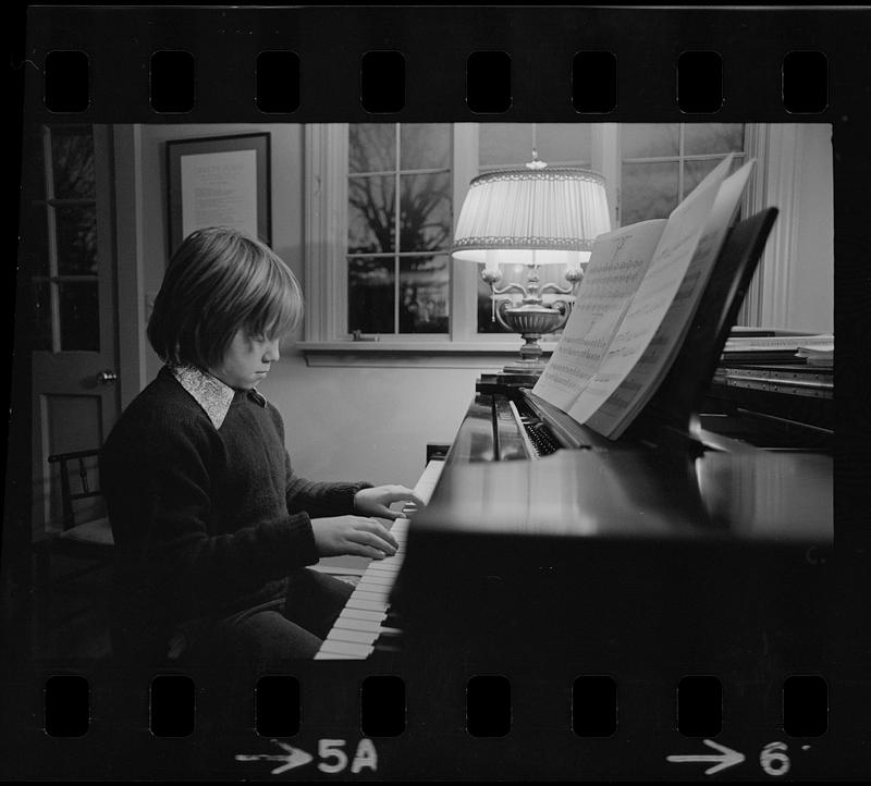 Bruce Irving's child playing the piano - Digital Commonwealth