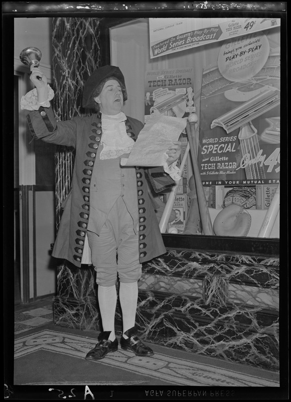 Man in town crier costume next to Gillette razor window display ...