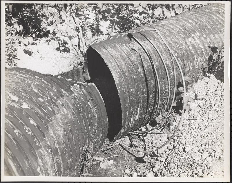 Large pipe on downstream side of dam showing four steel bands - Digital ...