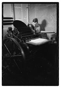 A man oiling a printing press - Digital Commonwealth