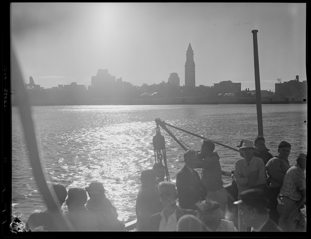 Skyline from crowded boat in harbor - Digital Commonwealth