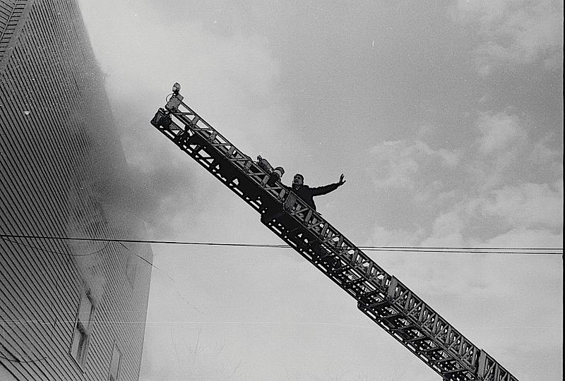 Making rescue over the ladder is Fire Alarm Signal Maintenance Man John ...