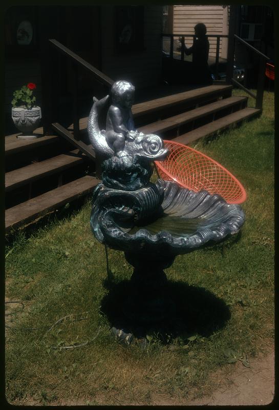 Water fountain with sculpture of child riding a fish - Digital Commonwealth
