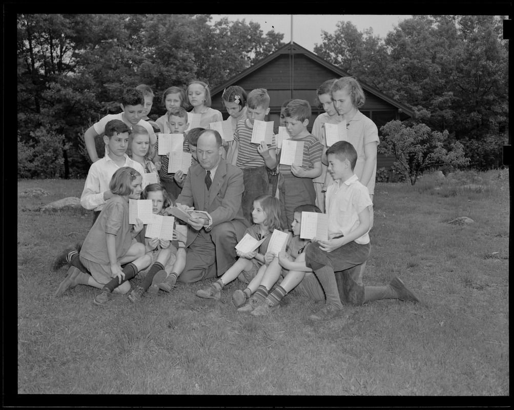 Edward J. Delaney showing U. S. defense savings stamps to children from ...