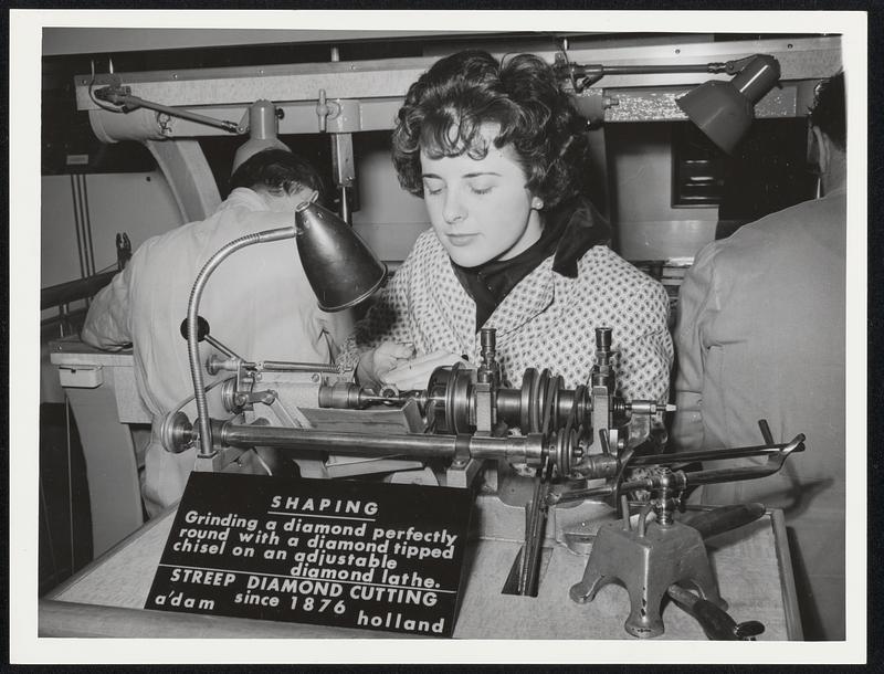Woman using diamond-cutting machine - Digital Commonwealth
