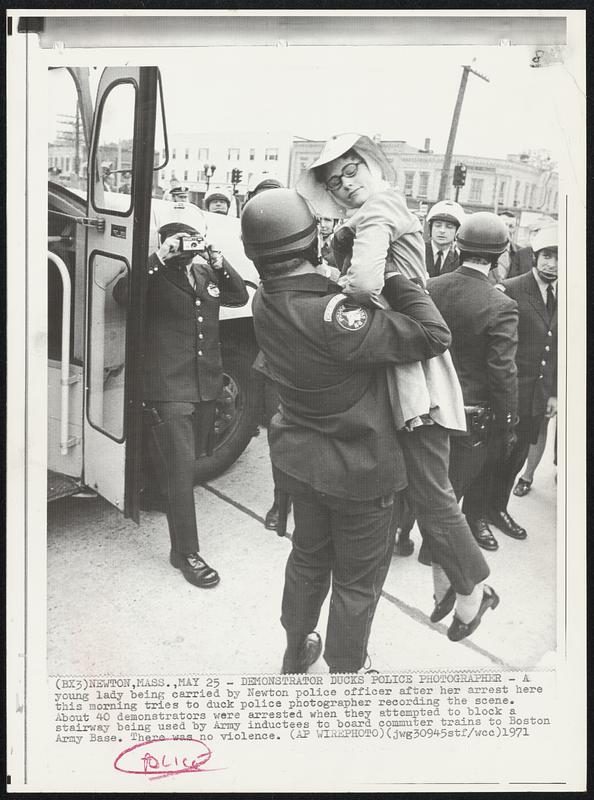 Newton, Mass. – Demonstrator Ducks Police Photographer – A young lady ...
