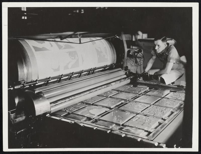 "Rolling" a map color form on a flat bed press. The plates pictured ...