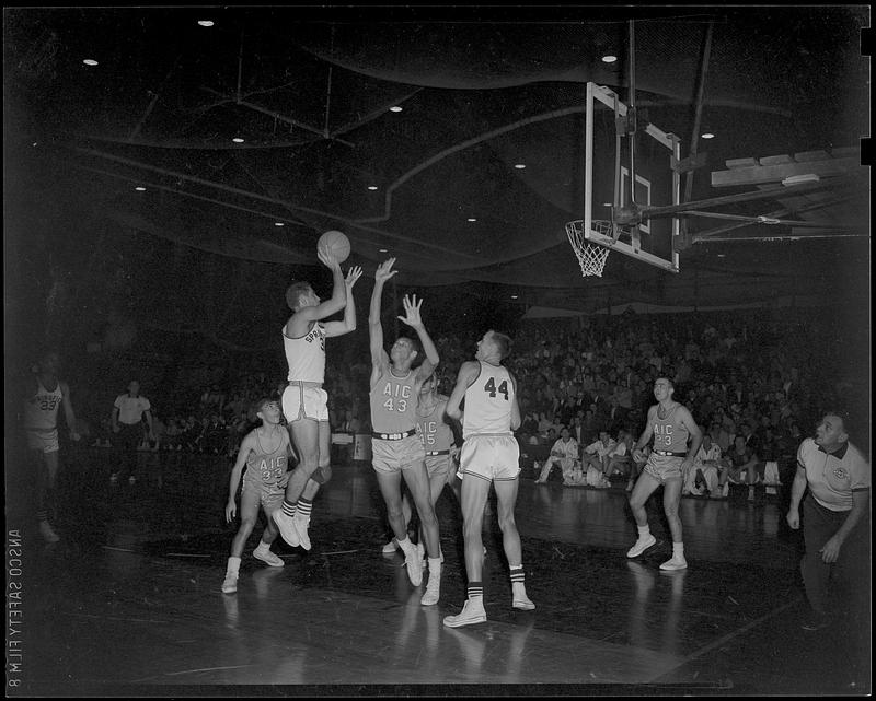 Springfield College basketball player taking a shot - Digital Commonwealth