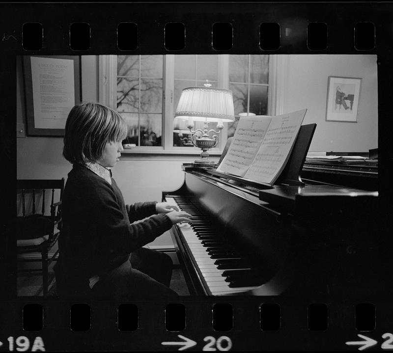Bruce Irving's child playing the piano - Digital Commonwealth