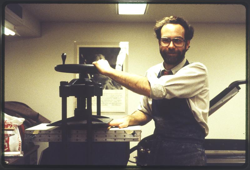 Stuart using book press - Digital Commonwealth