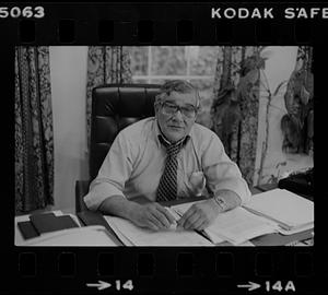 Peter Matthews at desk in office - Digital Commonwealth