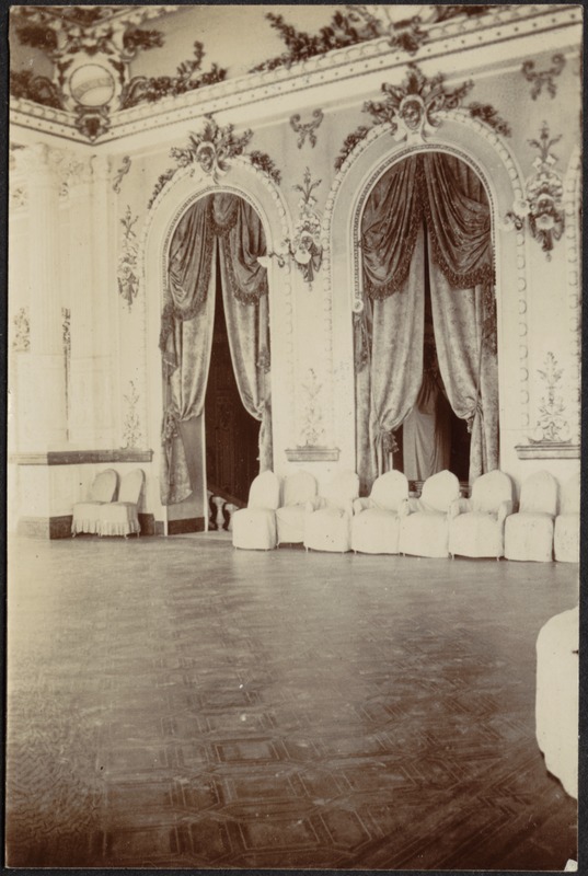 Ballroom lined with chairs, ornate neoclassical moldings on ceiling and ...