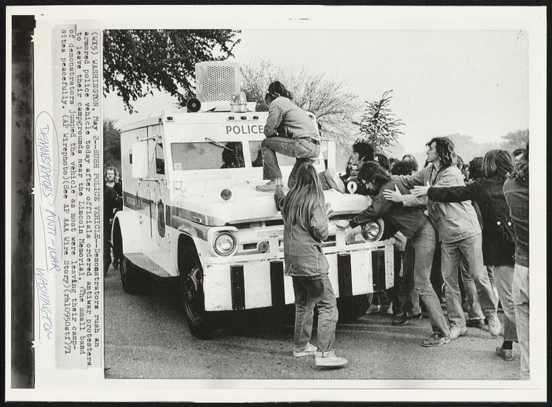 Rush Police Vehicle--Demonstrators rush an armored police vehicle today ...