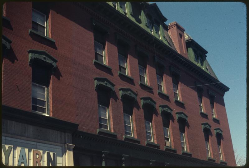 Windows of building with sign for yarn - Digital Commonwealth