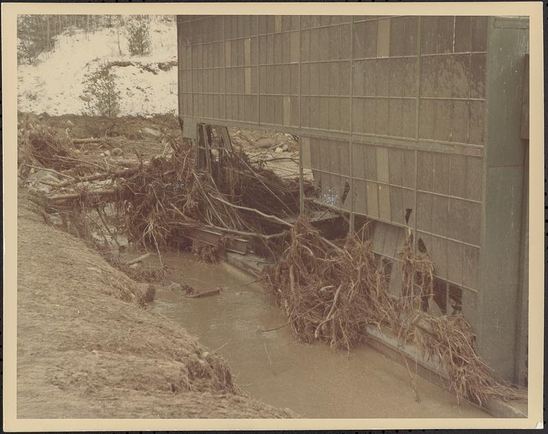 Flood debris and waters outside damaged factory - Digital Commonwealth