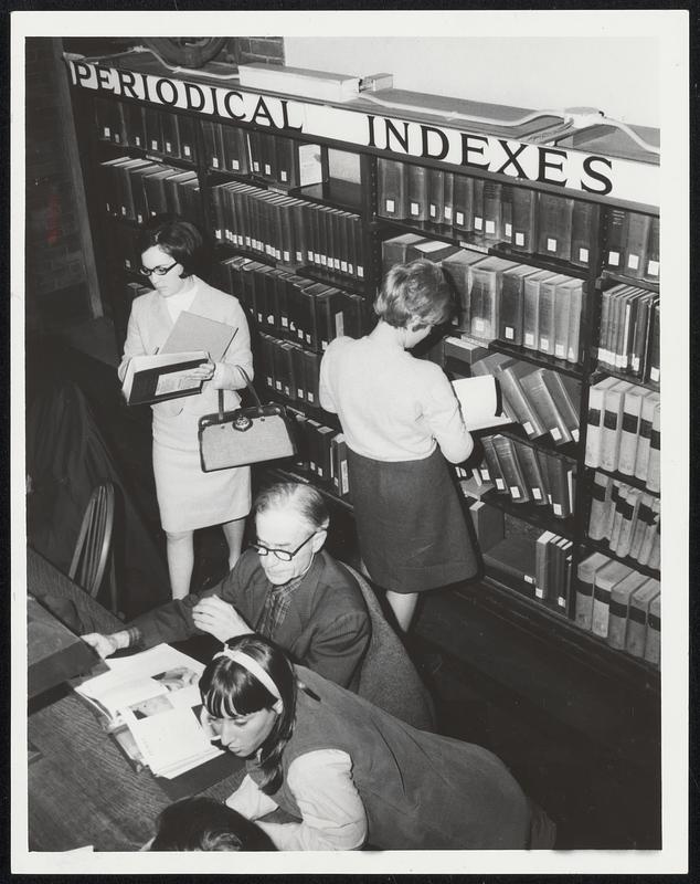 Surrounded by Students-In the periodical room a library patron reads in ...