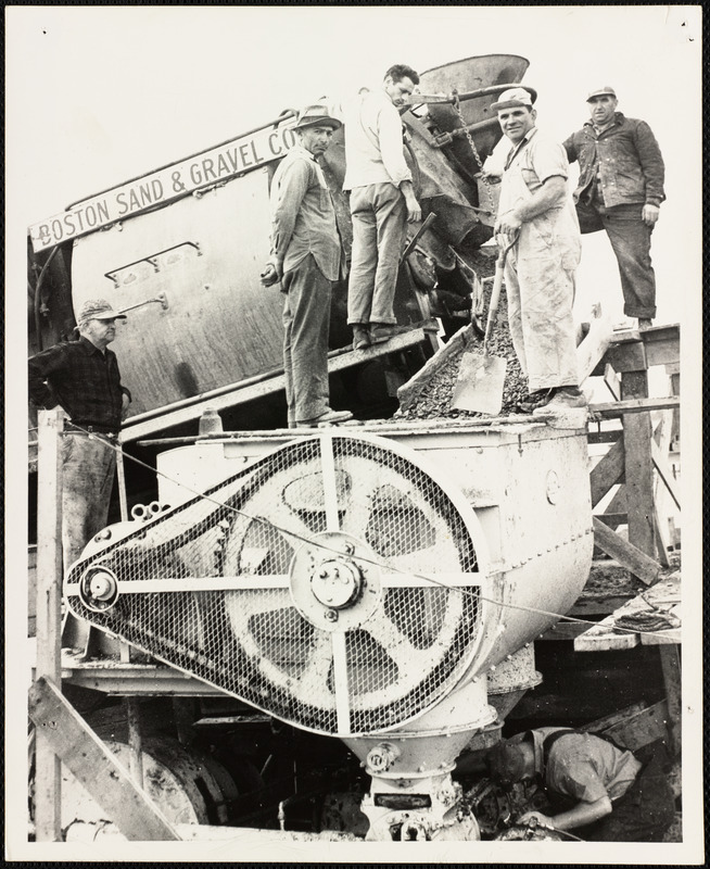 Construction workers standing atop Boston Sand & Gravel Company ...