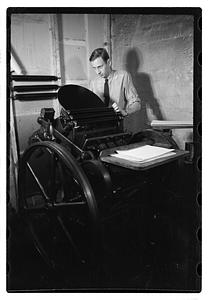 A man oiling a printing press - Digital Commonwealth