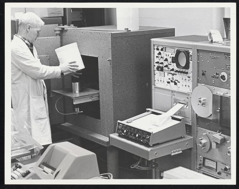 Technician George Burns is checking milk to determine Iodine 131 and ...