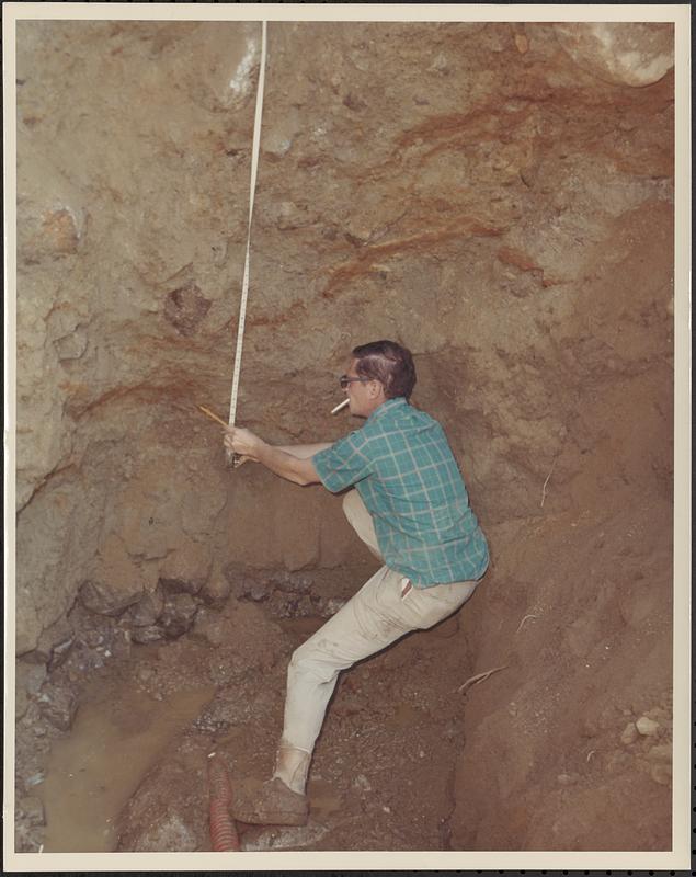 Dam engineer measuring trench - Digital Commonwealth