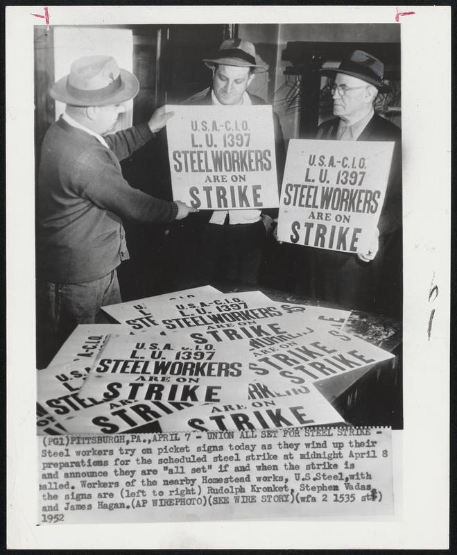 Union All Set for Steel Strike - Steel workers try on picket signs ...