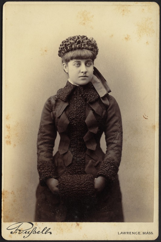 Portrait of Lila Sutton in winter dress with black lambswool muff ...