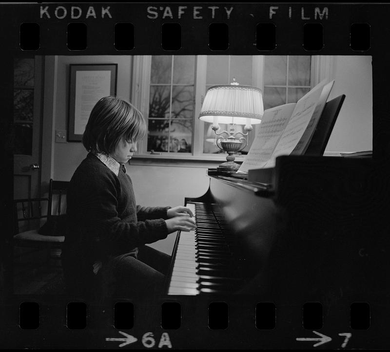 Bruce Irving's child playing the piano - Digital Commonwealth