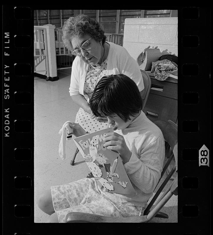 Retired volunteer "foster grandmother" works with retarded child at the ...