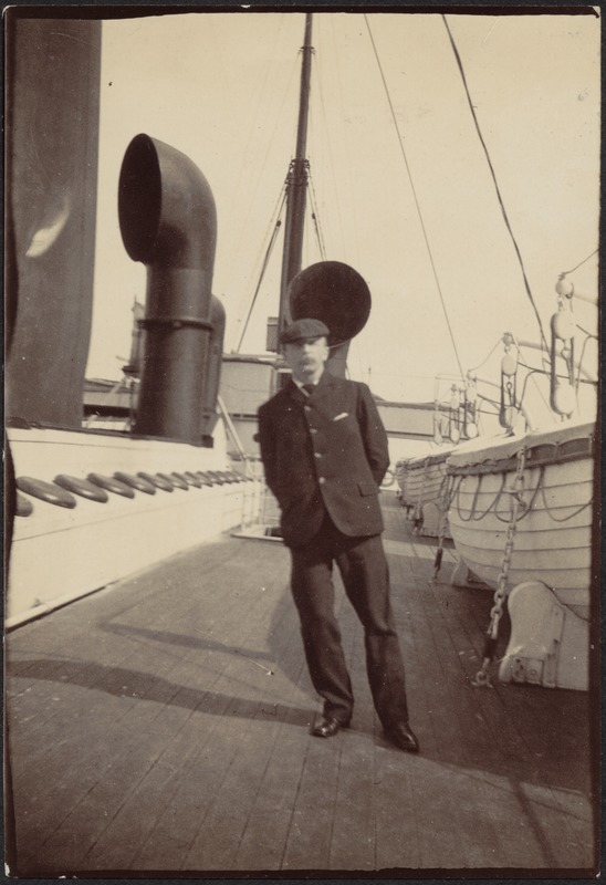 Man in cap standing on deck of ship - Digital Commonwealth
