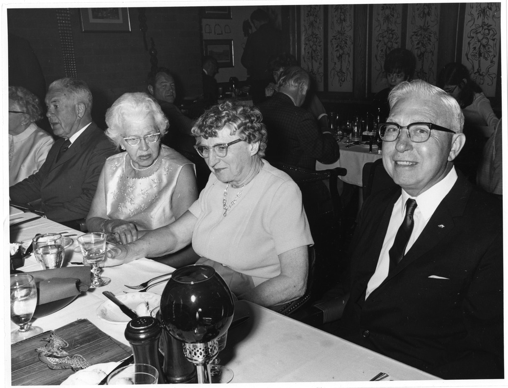 Group gathered at table for alumni event or reunion - Digital Commonwealth