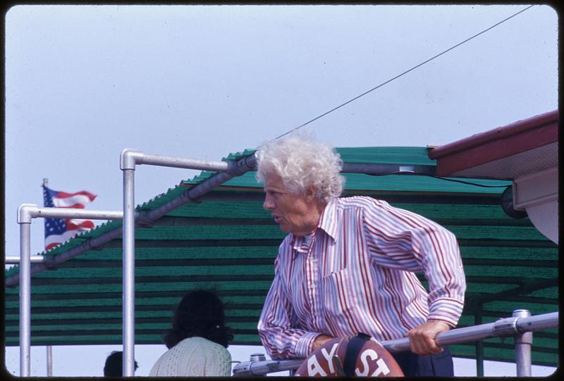 Person holding onto railing in front of green roof - Digital Commonwealth