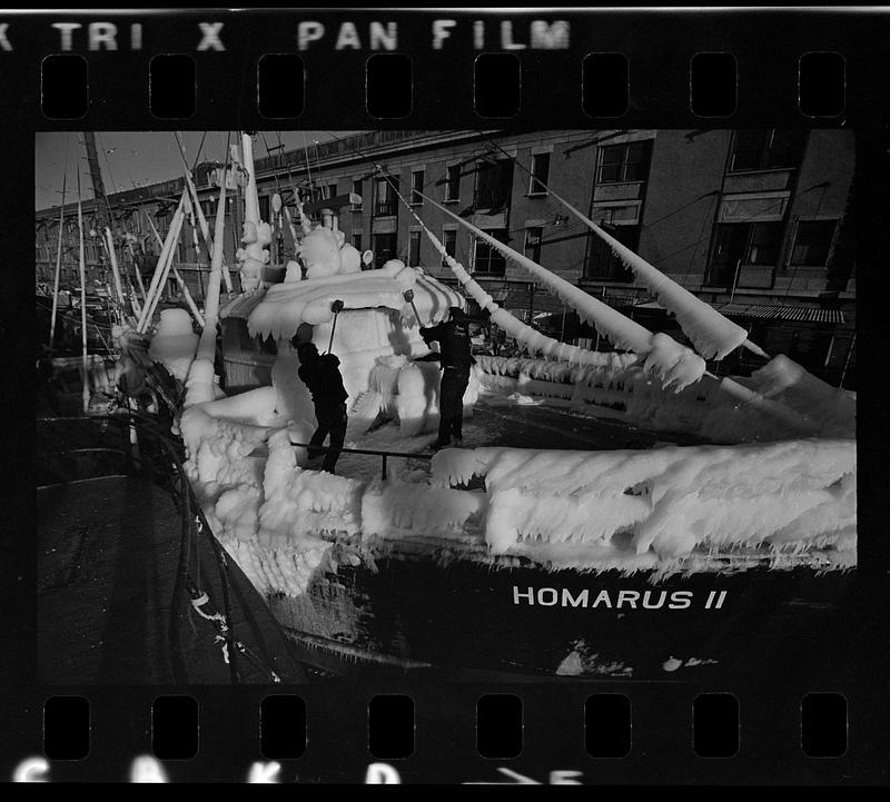 Chipping ice off fishing boat, Boston Fish Pier, Boston Harbor ...