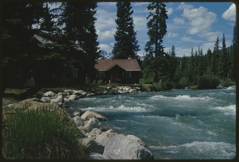Rapids in front of house set among trees, British Columbia - Digital ...