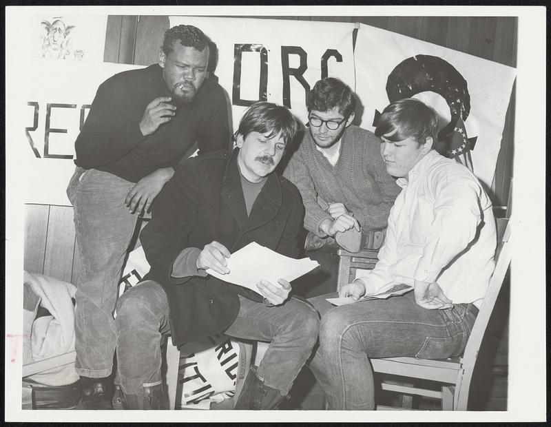 Draft resistance leaders explain literature to counselee. From left ...