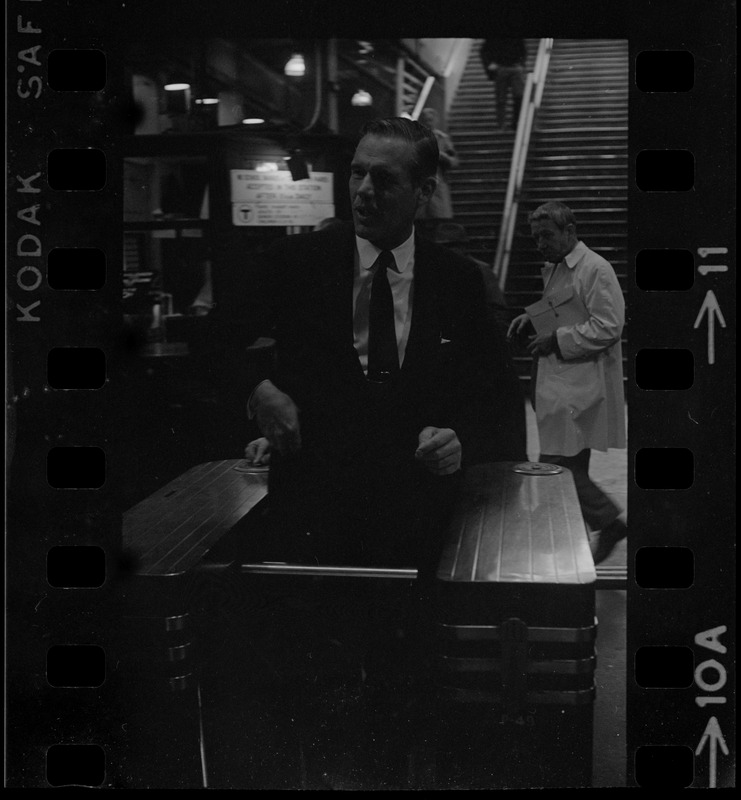 Governor Sargent going through a station turnstile while on a tour of ...