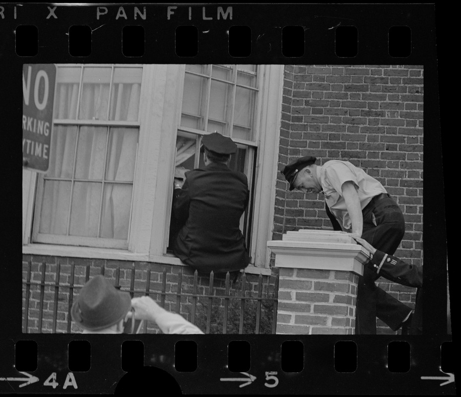 Police climb through window of house looking for suspects following an ...