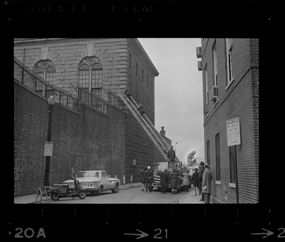 Police using fire department ladder truck to look over wall of Charles ...