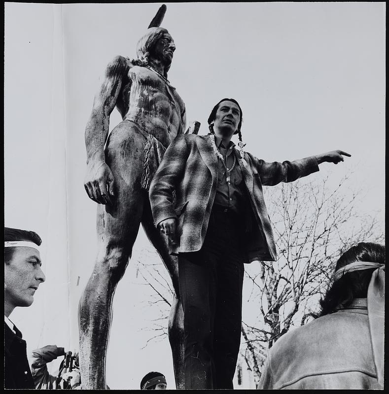 Russell Means speaking to crowd gathered around the statue of Massasoit ...