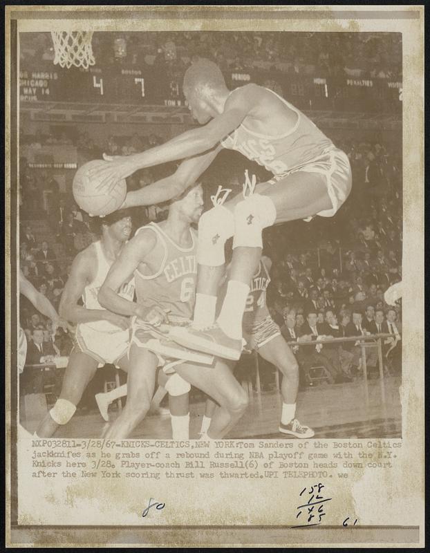 Knicks-Celtics, New York- Tom Sanders of the Boston Celtics jackknifes ...