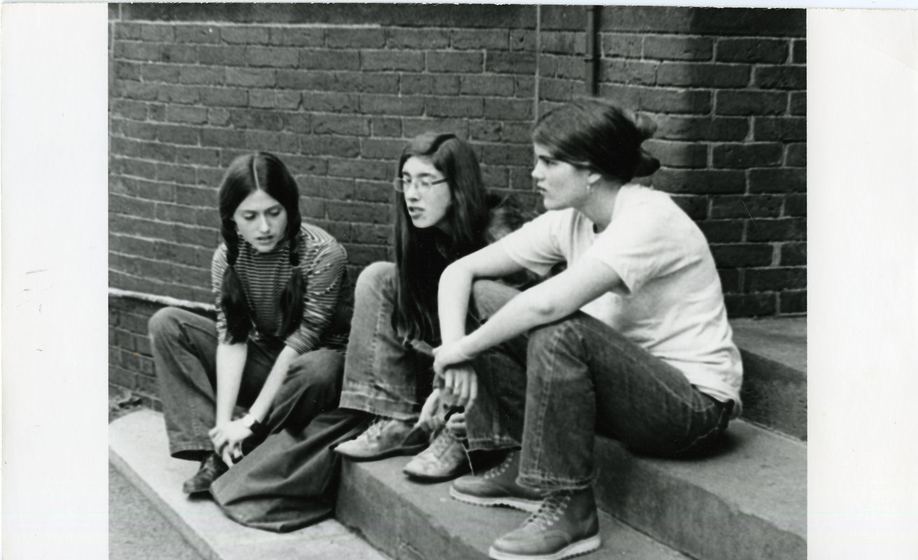 Ruth Cogan '75 and Ana Alvarez '73 sitting on steps - Digital Commonwealth
