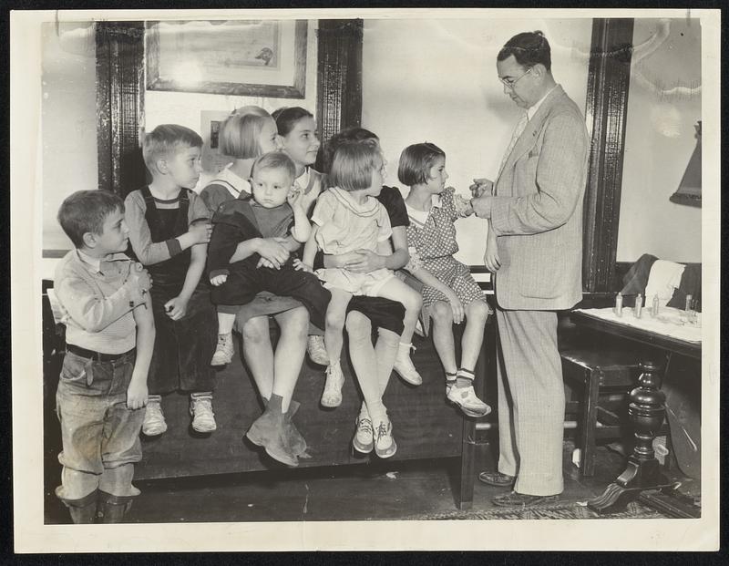 In a Ware refugee camp, Dr. Tracy Roberson is shown innoculating ...