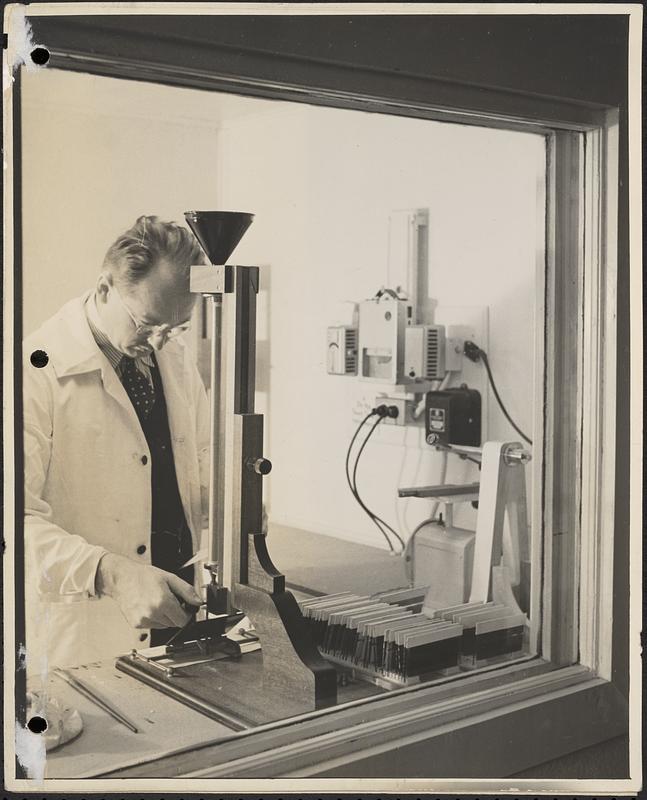 Interior view of text room through window showing technician testing ...