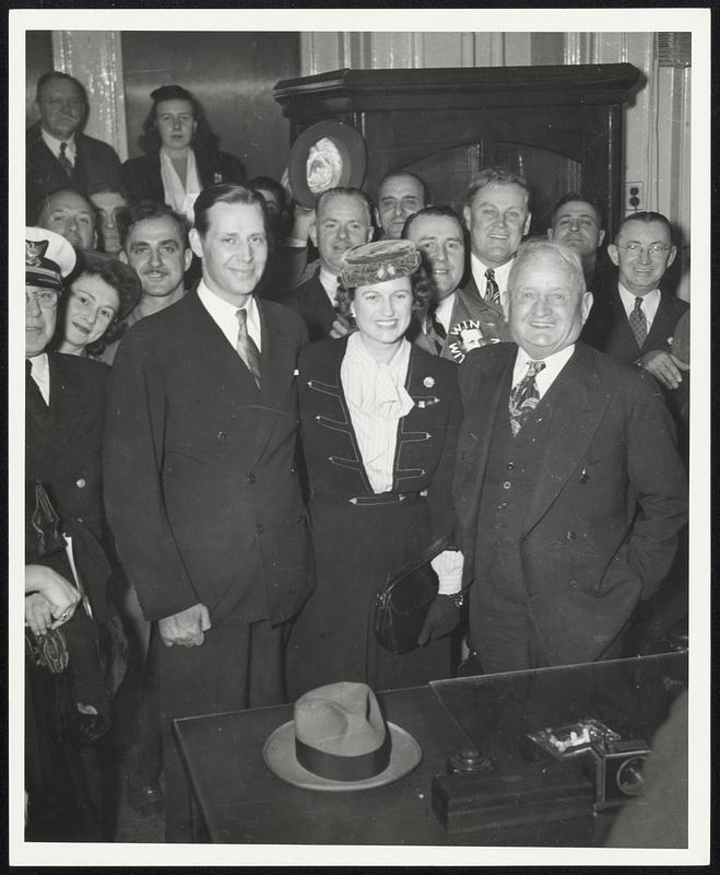Maaurice Tobin and his wife, Helen stand with a large group of people ...