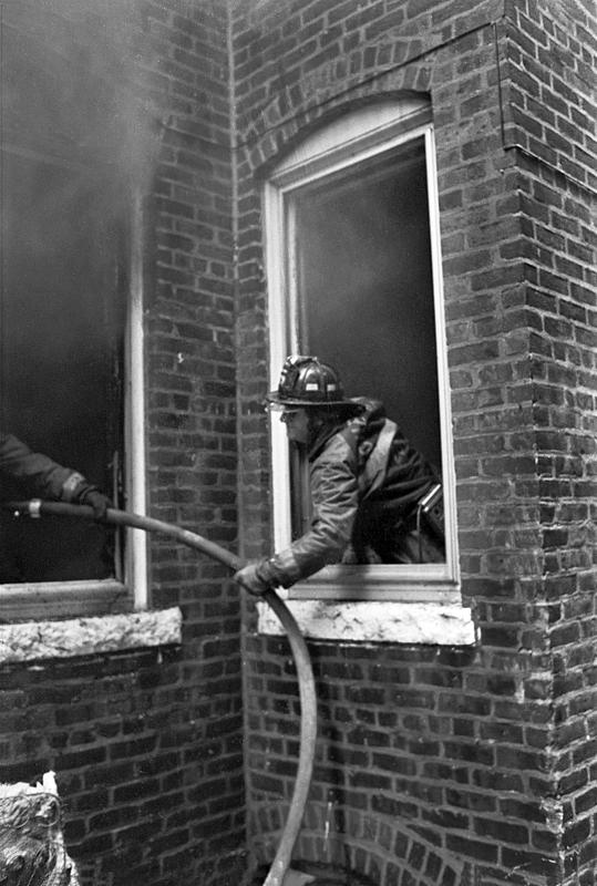 Firefighter Tom Lassiter passing a line through the window - Digital ...