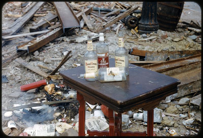 Empty bottles on table in debris, West End, Boston - Digital Commonwealth