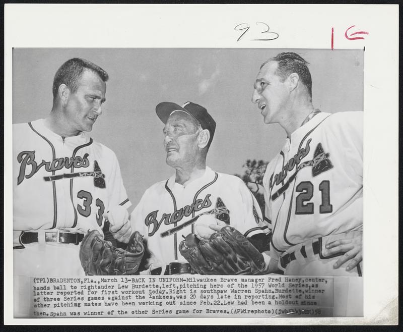 Back in Uniform-Milwaukee Brave manager Fred Haney, center, hands ball ...