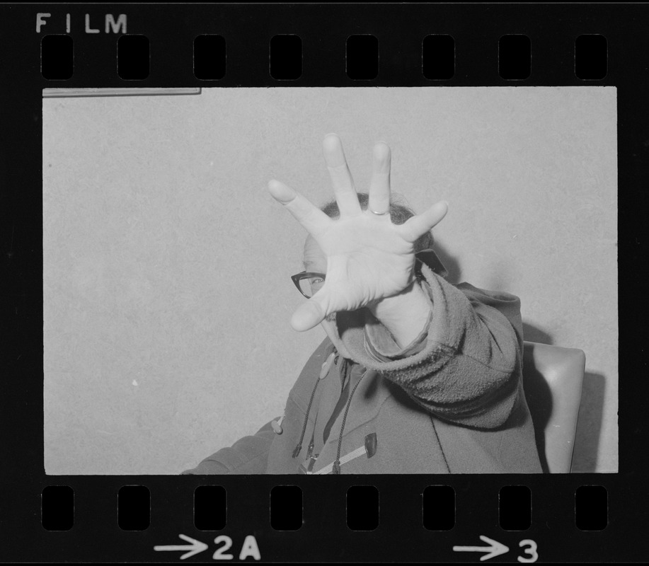 Man attempting to block camera with hand - Digital Commonwealth